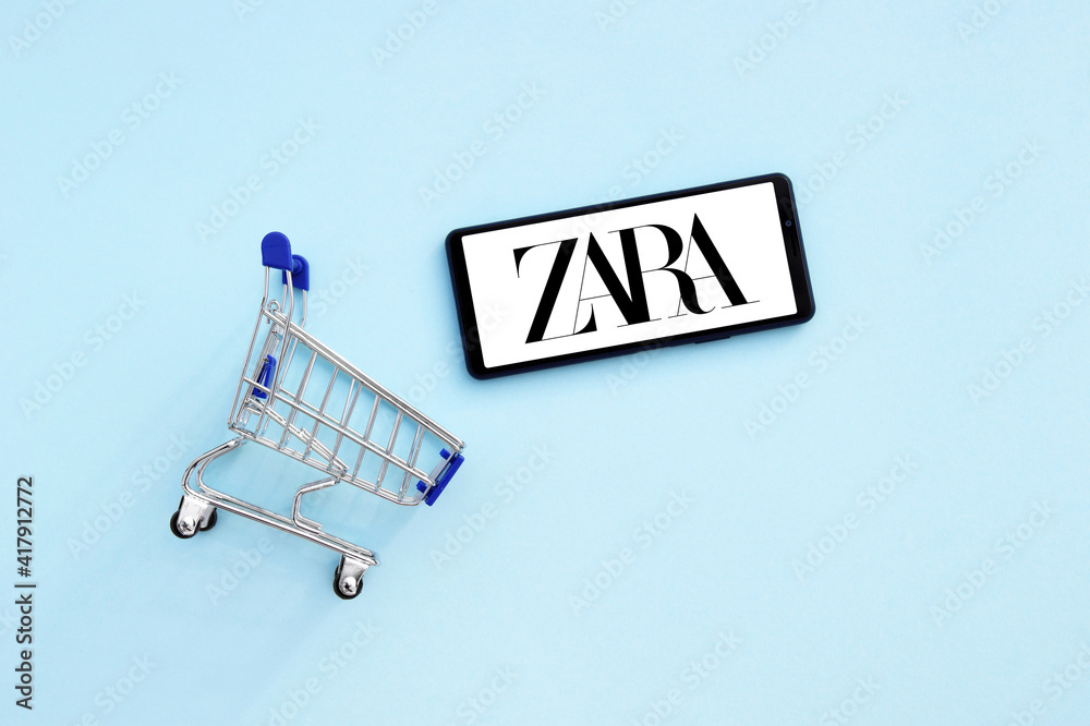 Shopping cart with a smartphone opened ZARA logo on the screen on a ...