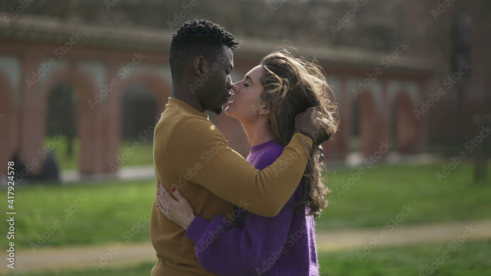 Interracial kiss and hug. Black man with while girlfriend kissing and ...