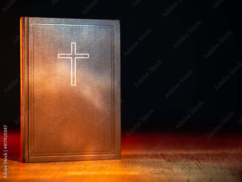 The Bible stands on a wooden table next to the text space. Religious ...