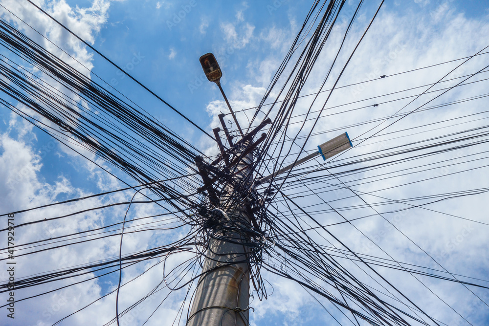 Foto de Power line post with lanterns. It is all entangled in an ...