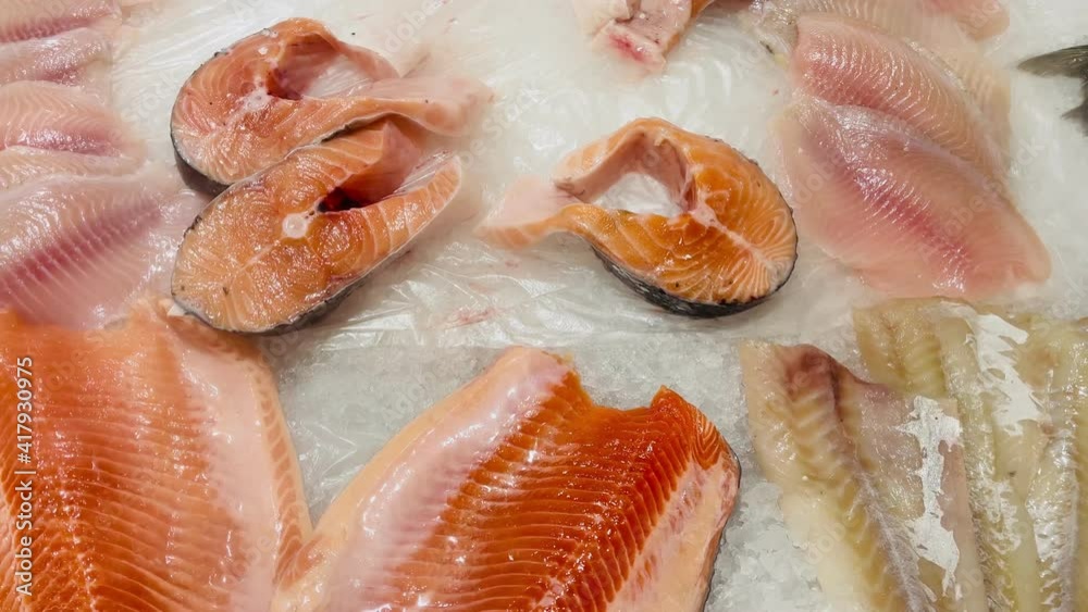 Close-up of fresh fillet of raw fish in pieces of ice. Chilled fish ...