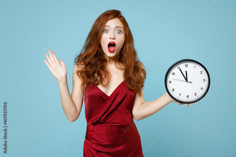 Young caucasian shocked surprised readhead curly woman in red party ...