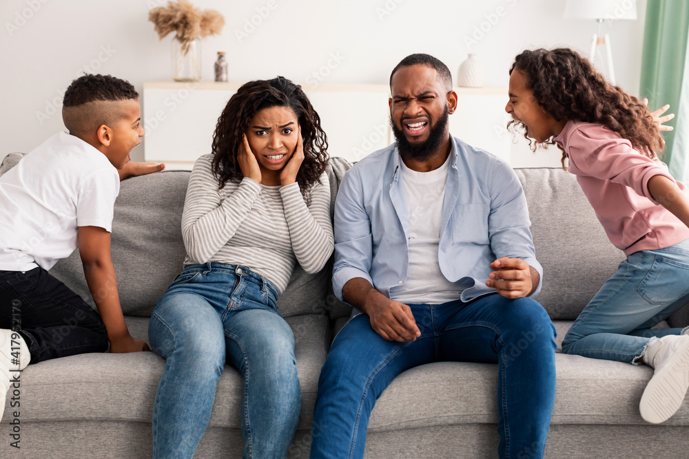 Angry black children fighting over their shocked parents Stock Photo ...