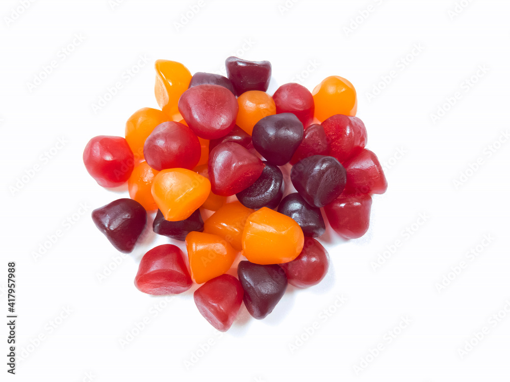 Close-up texture of red, orange and purple multivitamin gummies on ...