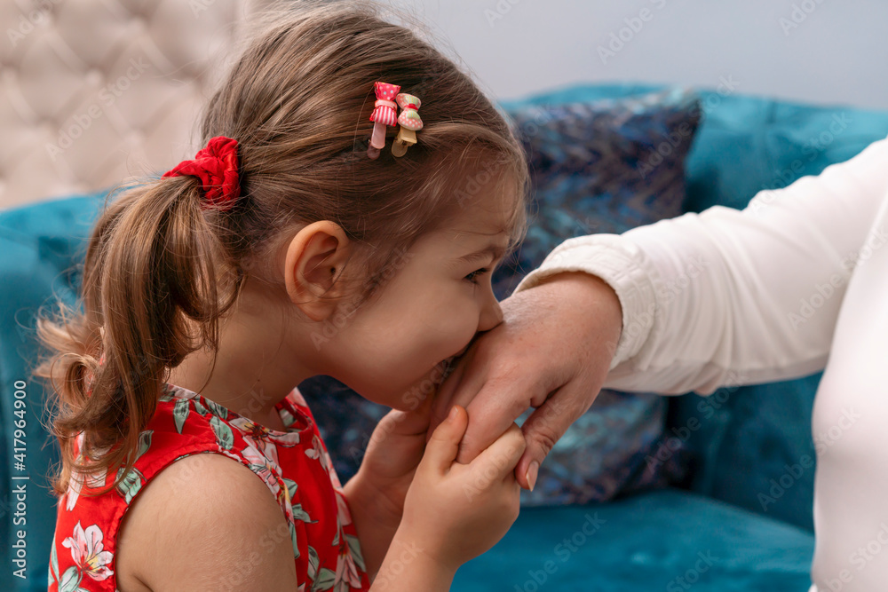 Little baby girl kiss her grandmother's hand during Eid mubarak ...