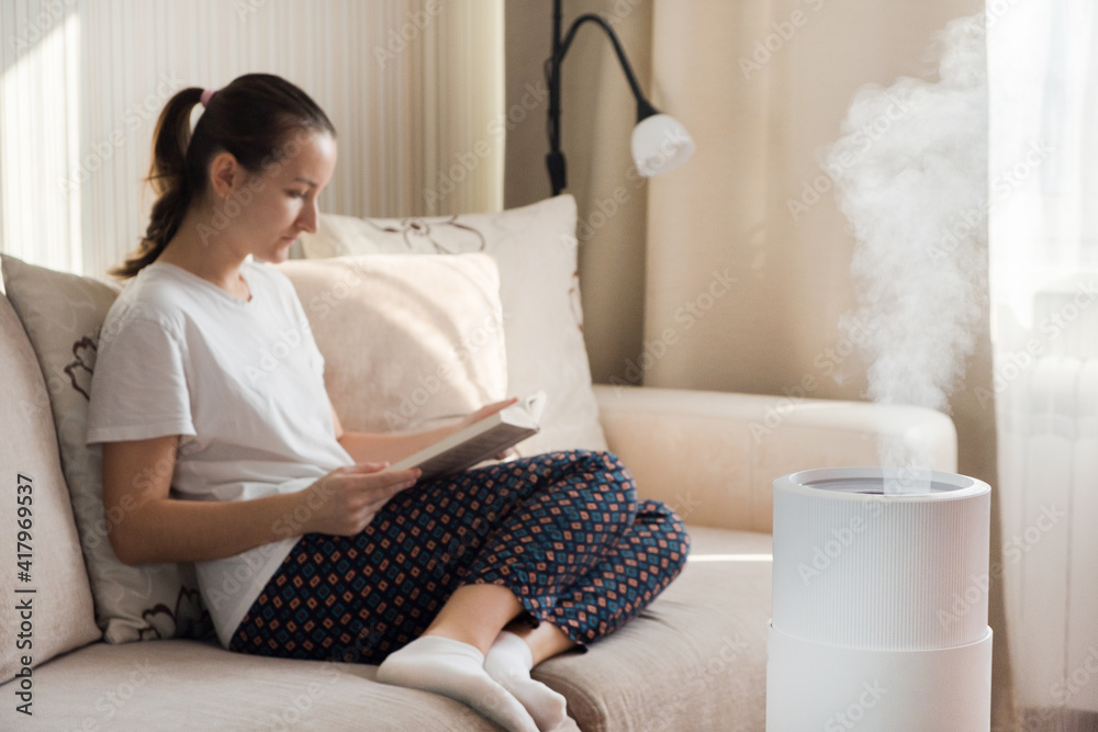 Modern air humidifier, aroma oil diffuser at home. Improving the ...