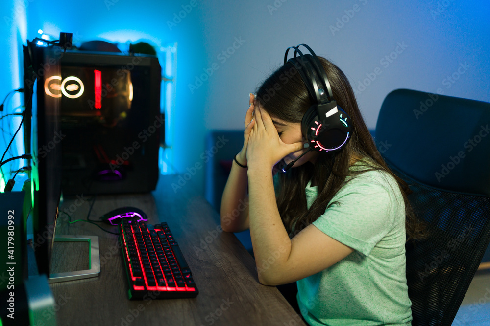 Sad woman gamer losing an online game match Stock Photo | Adobe Stock
