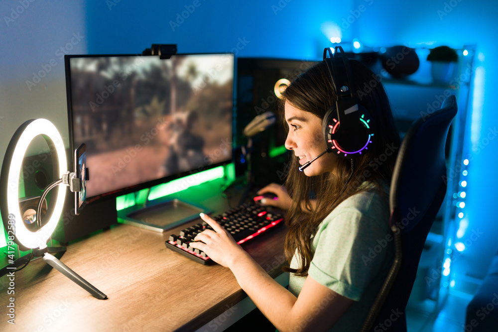 Caucasian woman gaming on a PC during a live stream Stock Photo | Adobe ...