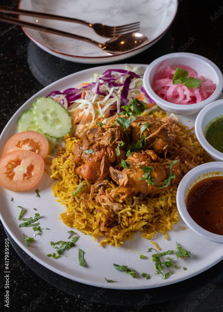 Islamic dish consisting of yellow rice with buried chicken and egg ...