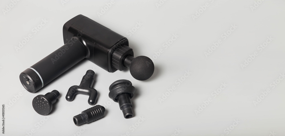 Handheld wireless professional therapeutic shock massage gun on gray ...