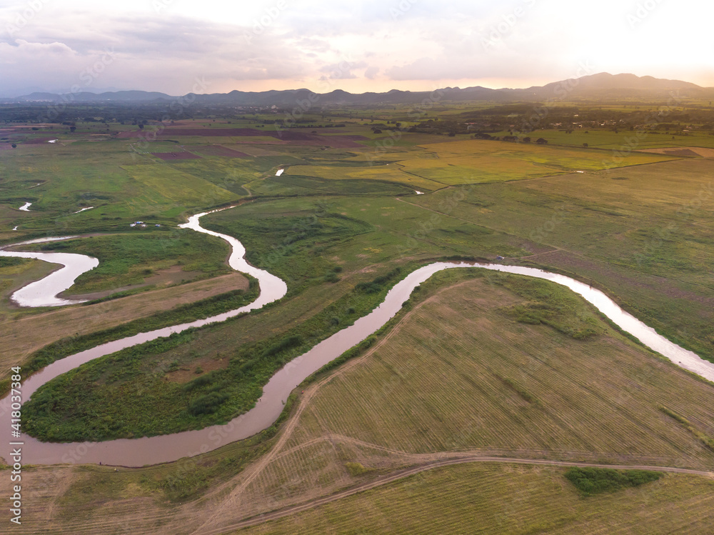 Scenic landscape aerial view of field river and basin against a natural ...