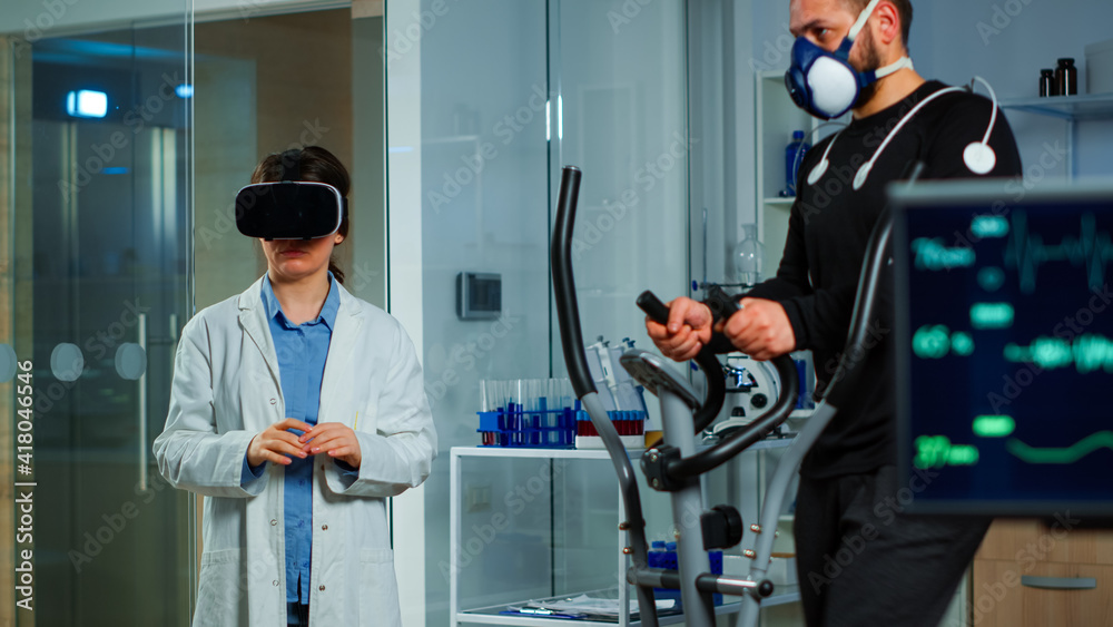 Scientist doctor in sport science laboratory wearing virtual reality ...