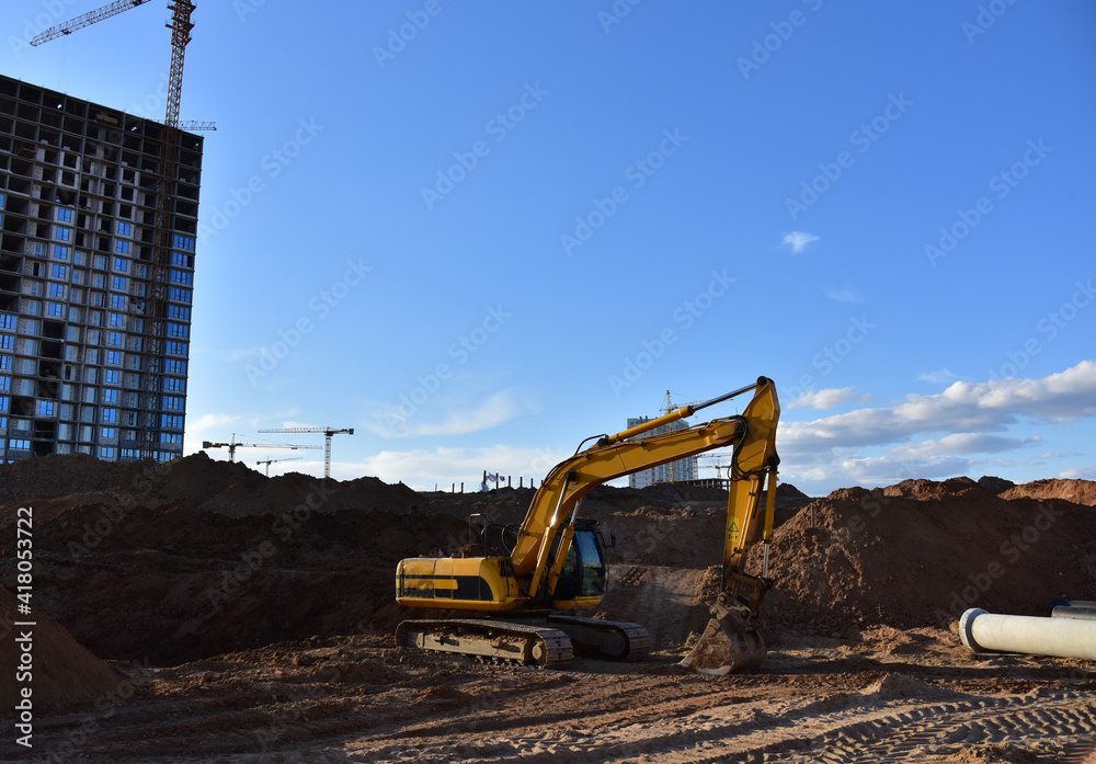 Excavator dig trench at construction site. Digging the pit foundation ...