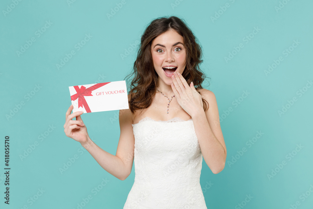 Shocked bride young woman 20s in beautiful white wedding dress hold ...