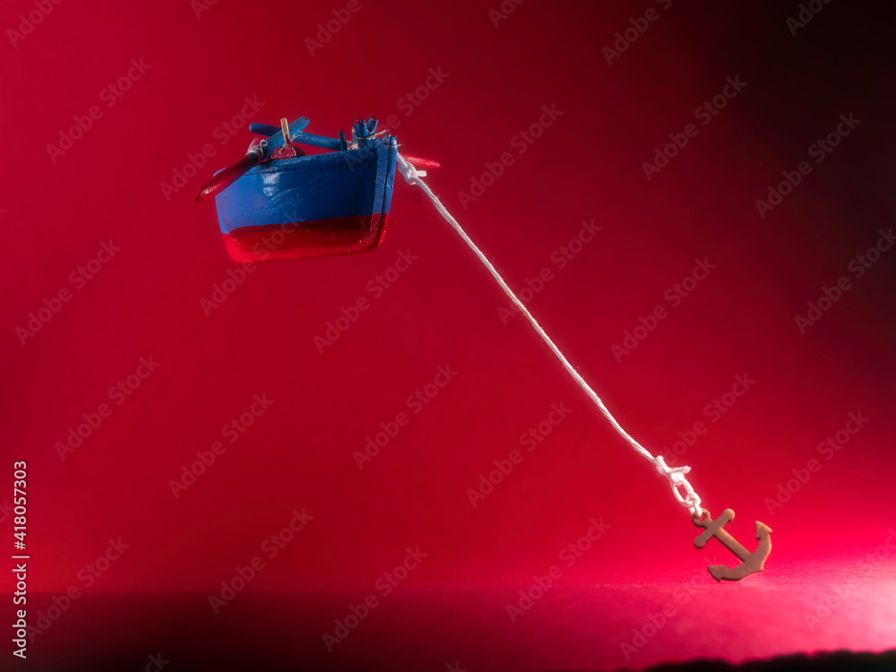 Conceptual rowing boat floating mid air while dropping anchor Stock ...