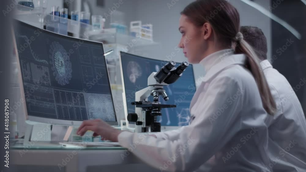 Female doctor working in laboratory. Studying human skeleton and DNA ...