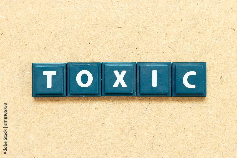 Tile alphabet letter in word toxic on wood background Stock Photo ...