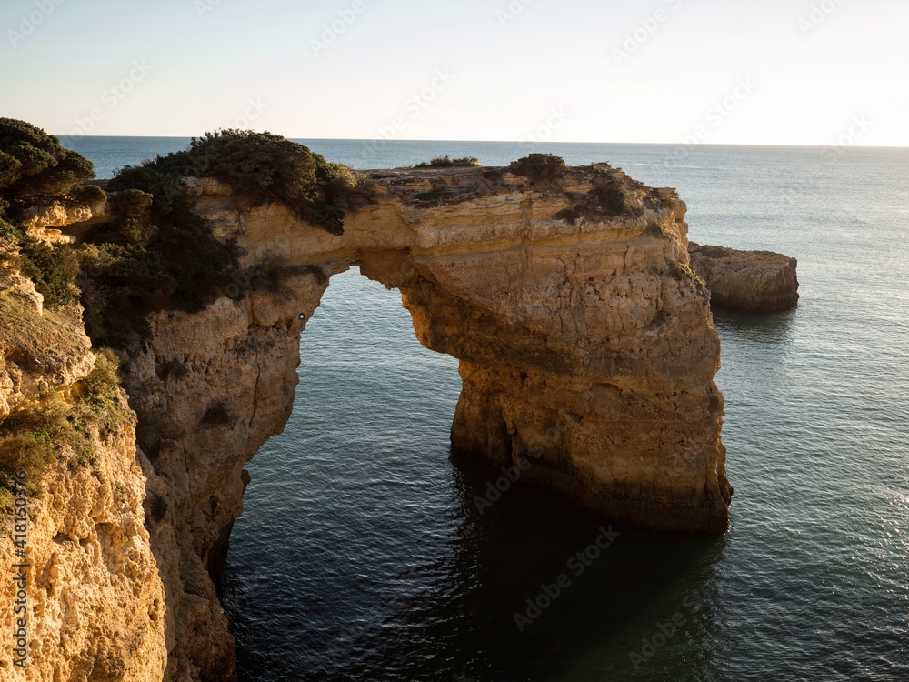 Panorama view of natural limestone arch bridge Arco de Albandeira beach ...