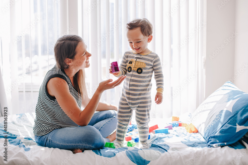 Foto de Mother and baby toddler playing building with learning toy ...