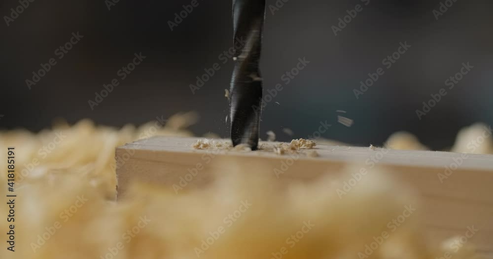 Macro video: drilling holes in wooden plank in slow motion, carpentry ...