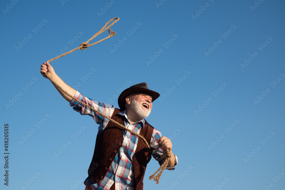 Lasso throwing. Old wild west cowboy with rope. Bearded western man ...