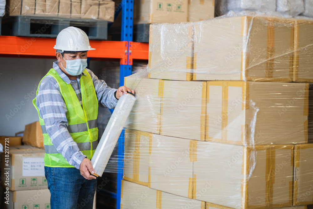 man worker wearing protective face mask and safety suite wrapping ...
