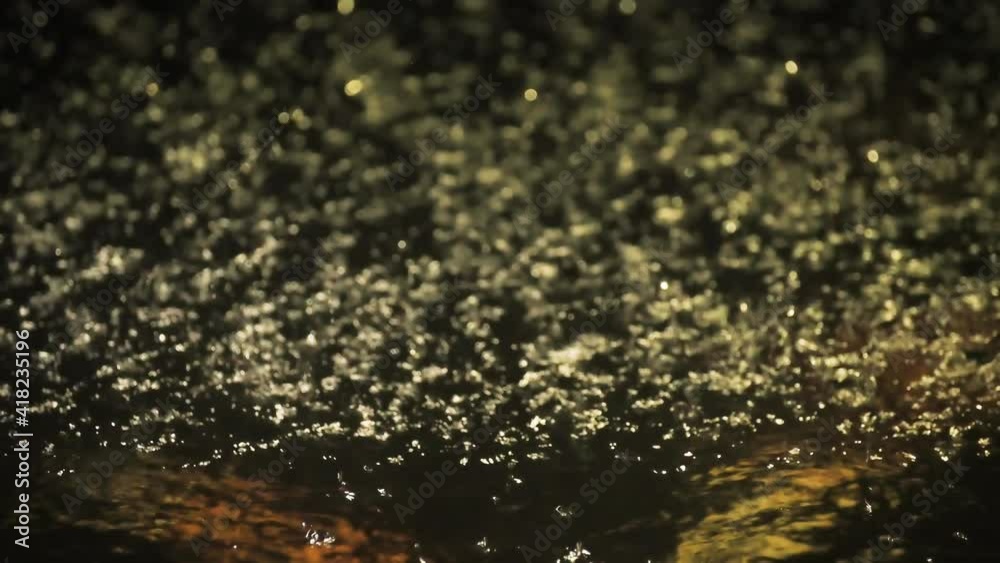 Low angle view of water surface fish pond during raining, showing water ...