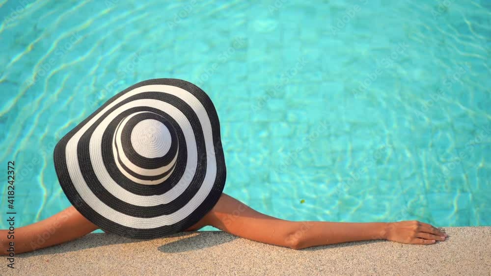 A woman with her back to the camera and wearing a huge black and white ...
