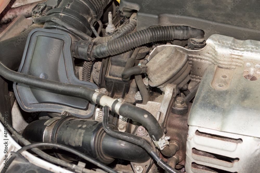Air ducts and pipes under the hood of the car Stock Photo | Adobe Stock