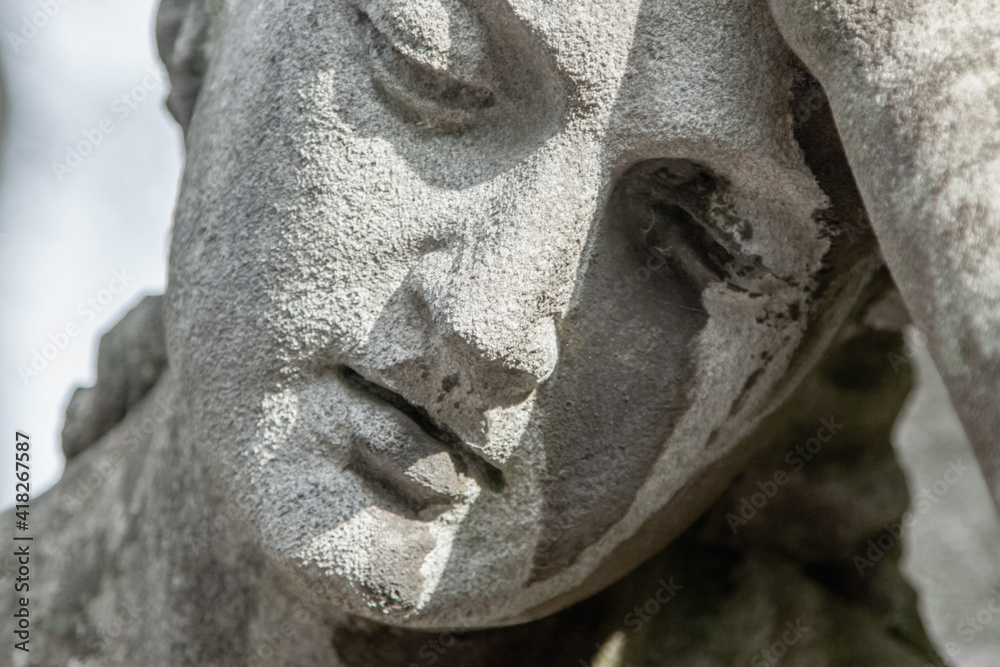 Ancient stone statue of sad man on tomb as a symbol of death ...