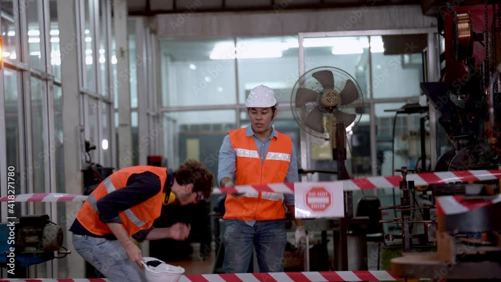 factory worker walking out restricted area in factory workplace. young ...