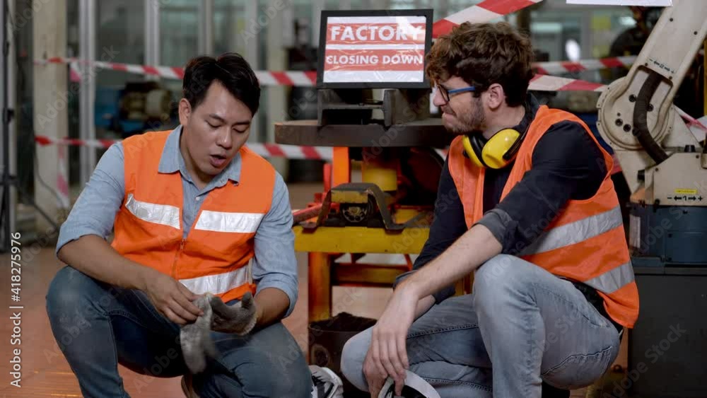 factory worker sitting out restricted area in factory workplace. young ...