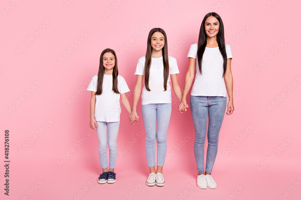 Full length body size photo mother daughters smiling holding hands ...