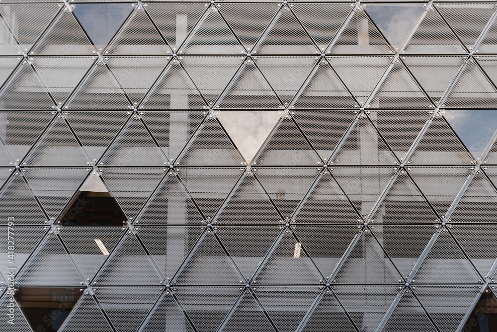 Modern building facade features a triangles pattern. Construction ...