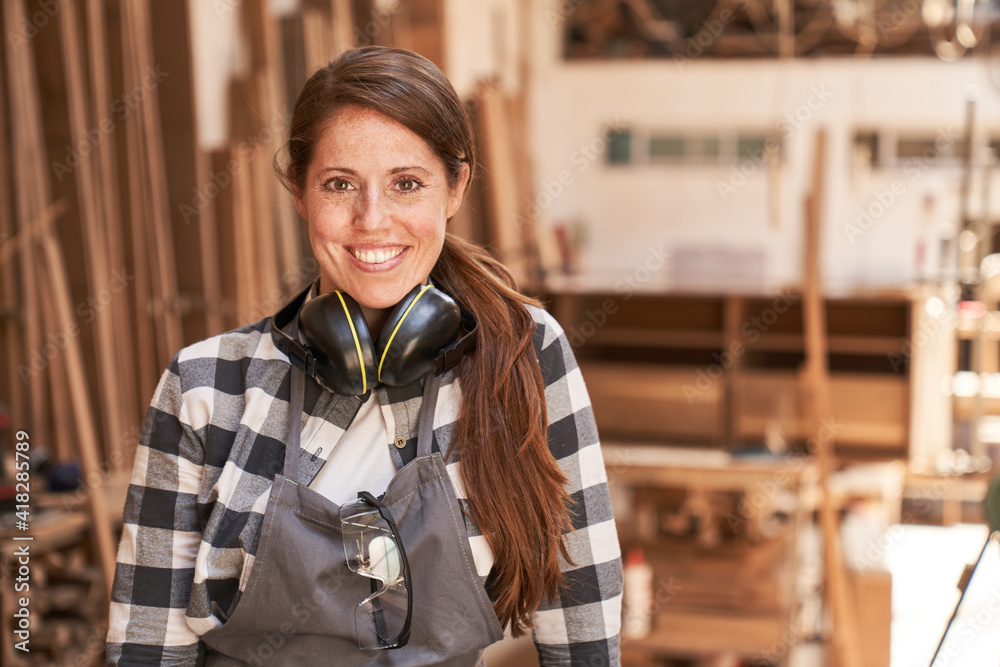 Happy young woman as a craftsman apprentice Stock Photo | Adobe Stock