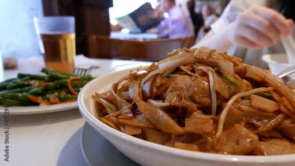 People eating congee with fried rice noodle on the table inside Hon's ...