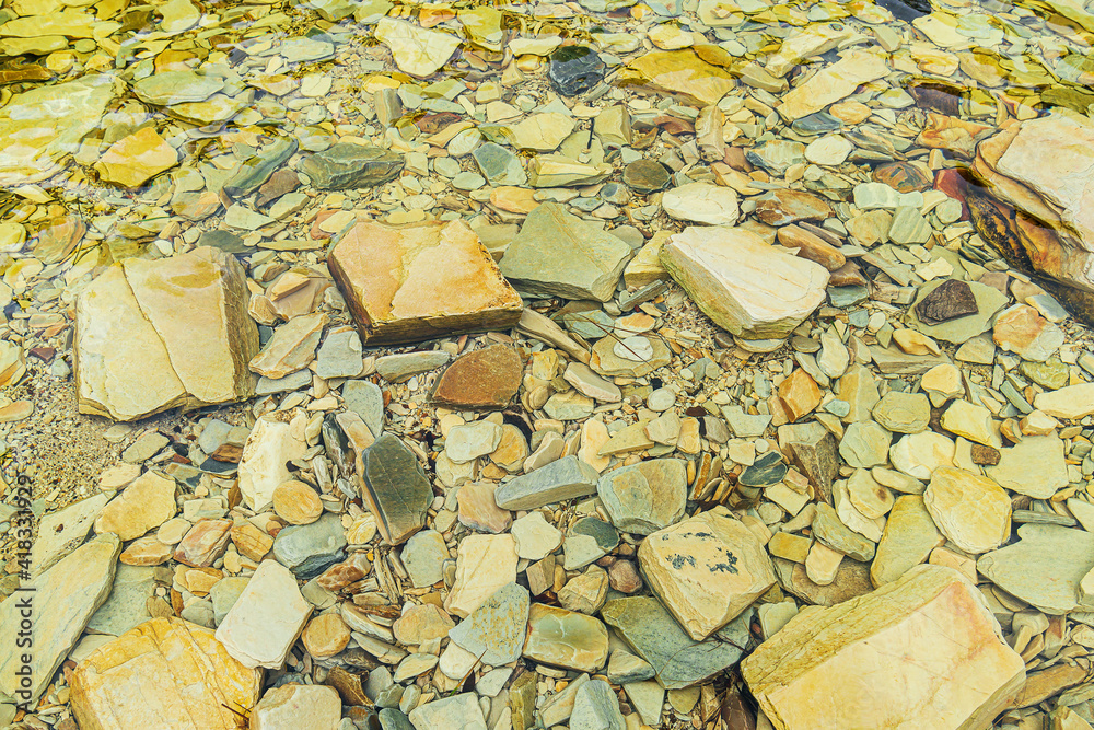 Underwater sedimentary rocks. Rocks in different shapes submerged on a ...