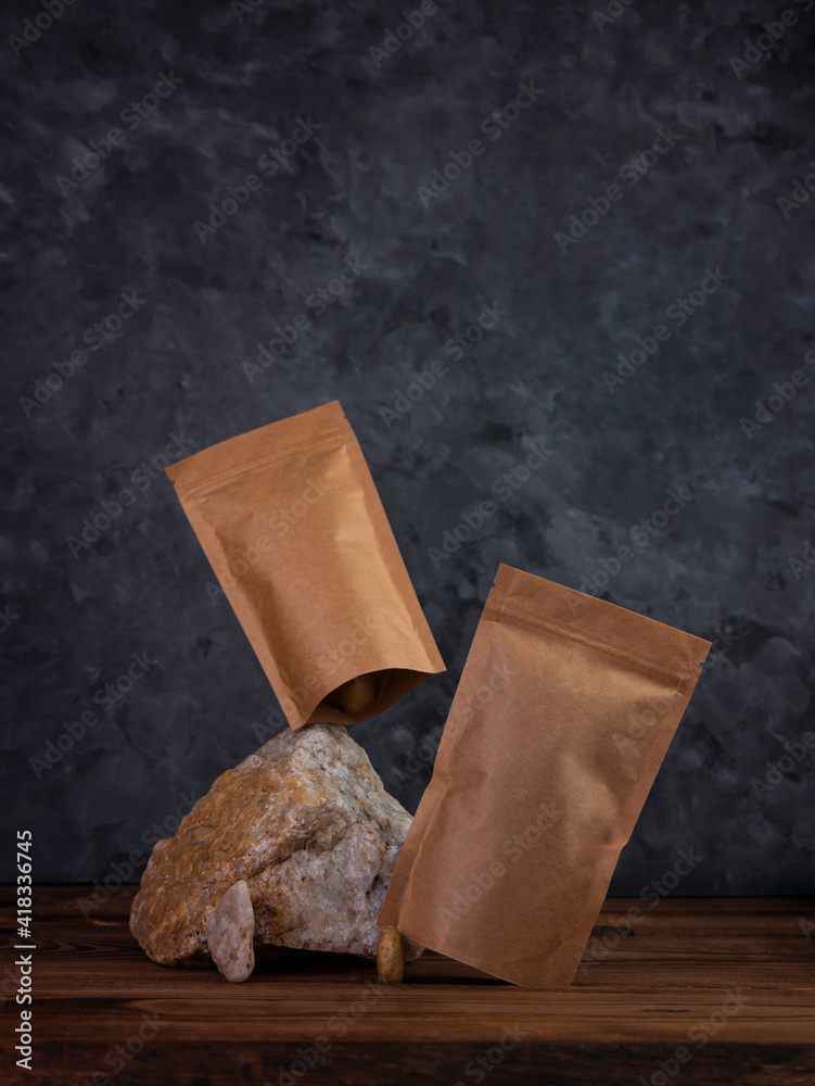 Balancing pouch bag mockup on natural stone. Blank kraft paper pack ...