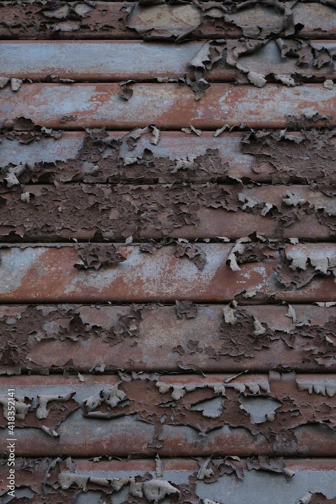 Saracinesca arruginita. Peeled paint on a rusty shutter. This photo ...
