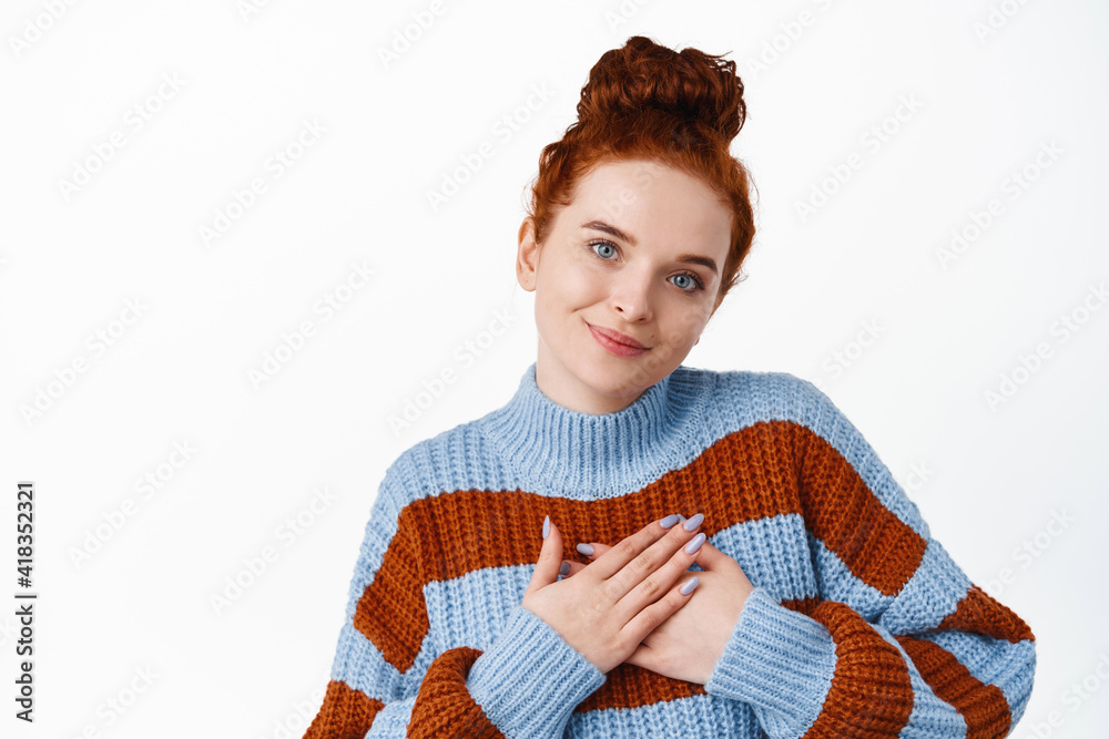 Portrait of tender smiling ginger girl with combed hair, holding hands ...