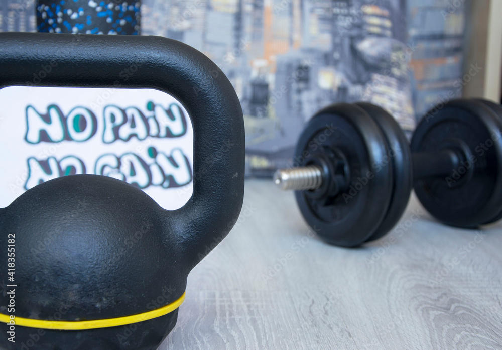 Gym dumbbell, kettlebell with motivational poster /Train hard/ for ...