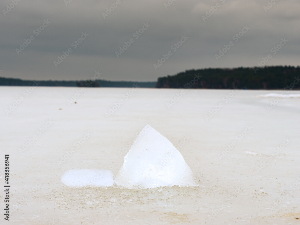 Sharp ice teeth. Melting ice block seen on the beach of glacier lagoon ...
