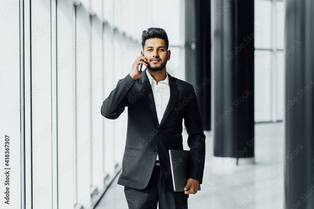 Portrait of a handsome smiling serious Indian man, office worker ...