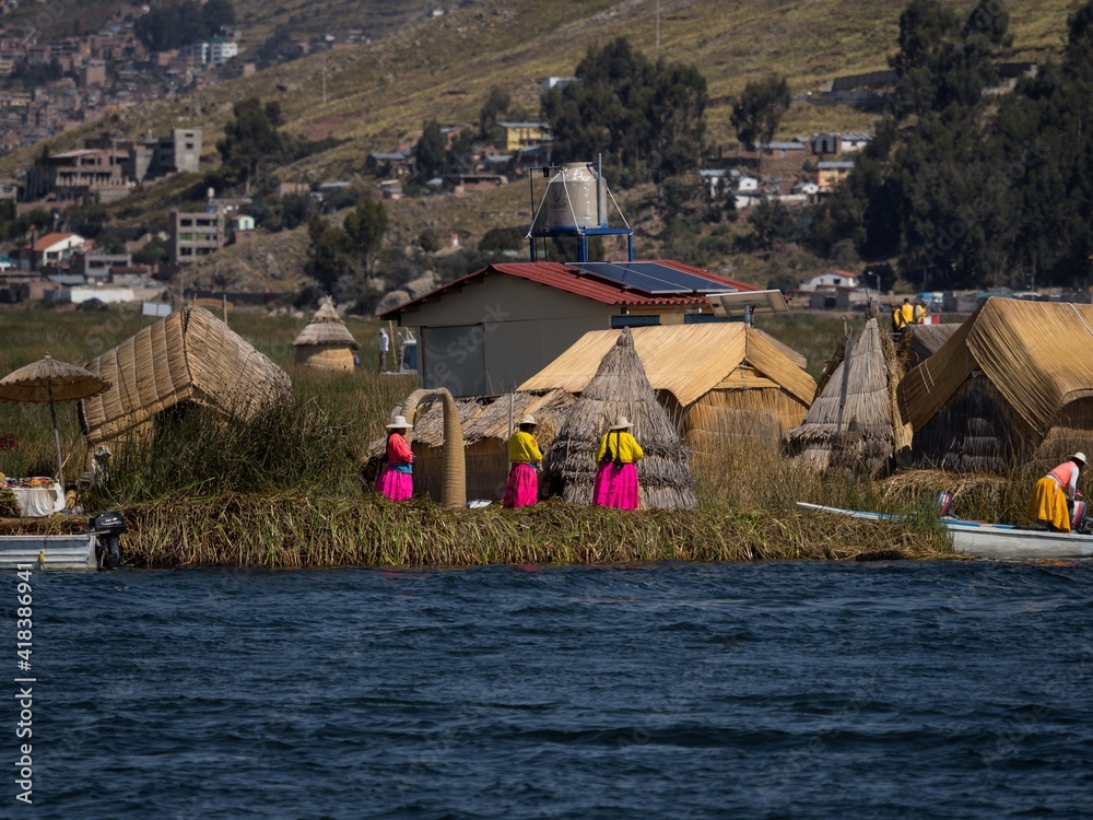 Indigenous women in colorful traditional dresses on Uros Floating reed ...
