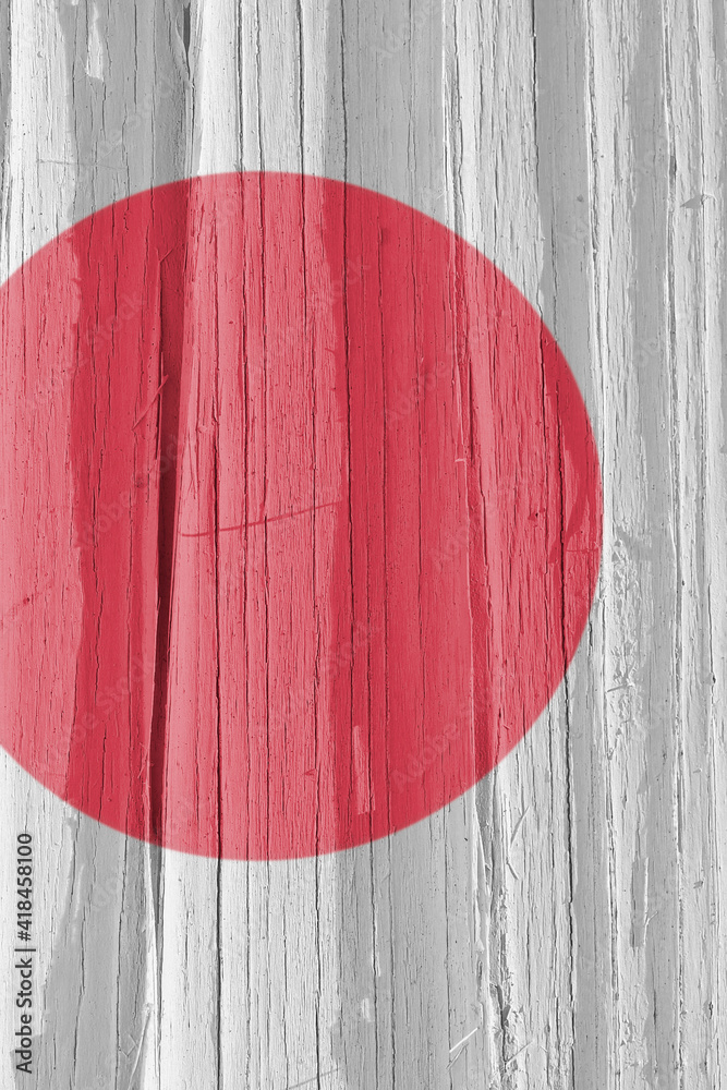 Fragment of Japan flag on a dry wooden surface, cracked with age. Light ...