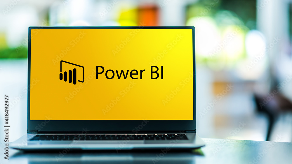 Laptop computer displaying logo of Microsoft Power BI Photos | Adobe Stock