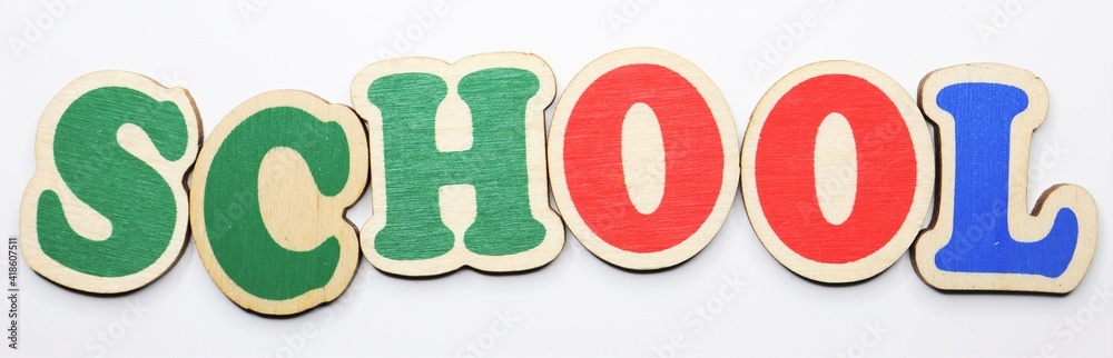 The English word "school" made of colored wooden letters on a white ...