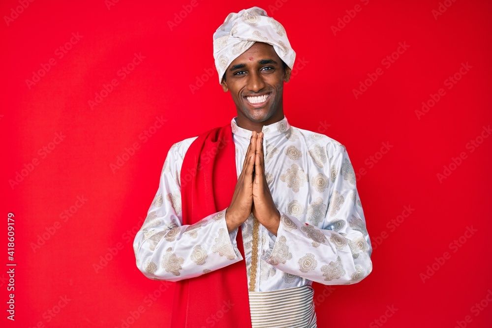 Handsome indian man wearing tradition sherwani saree clothes praying ...