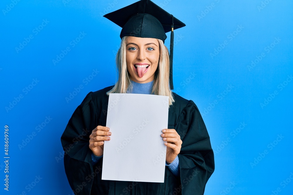 Beautiful blonde woman wearing graduation cap and ceremony robe holding ... Beautiful blonde woman wearing graduation cap and ceremony robe holding ...
