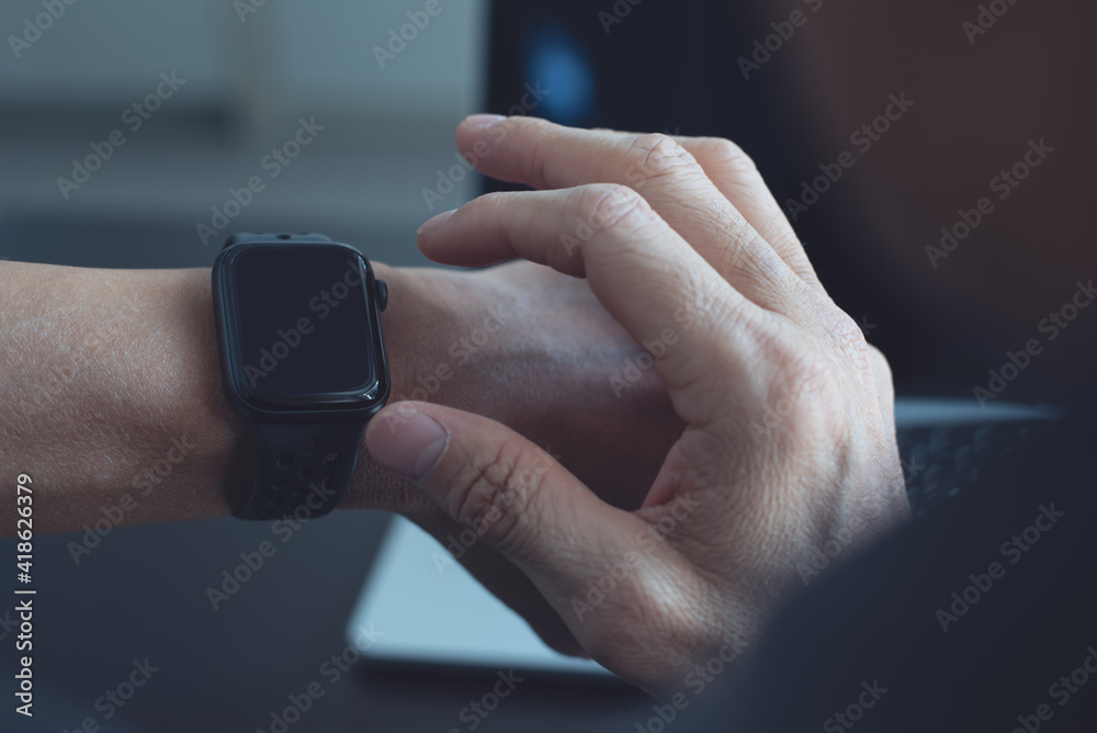Businessman wearing smartwatch with blank black screen template mockup ...